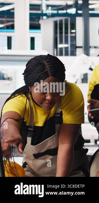 Vertical Video Black team of manufacturing plant employees fixing ...