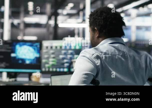 Server room programmer with paraplegia interprets AI generated data analytics graphs. Man in ...