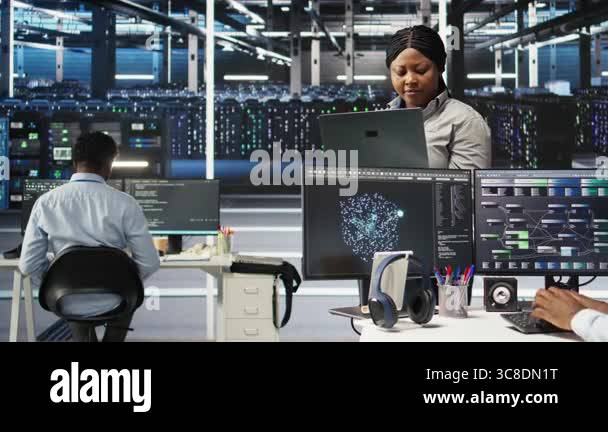 Cheerful data center employee using node tree software to analyze datasets. Upbeat server ...