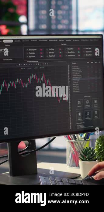 Vertical Video Stock market investor monitors digital charts and ...