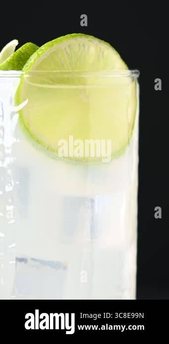 Rotating gin Fizz cocktail with lime on black background Stock Video ...
