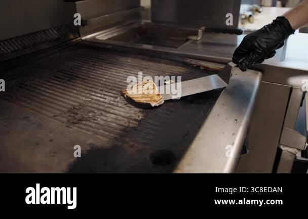 Chef Grabbing The Grilled Swordfish And Putting It In The Dish Stock ...