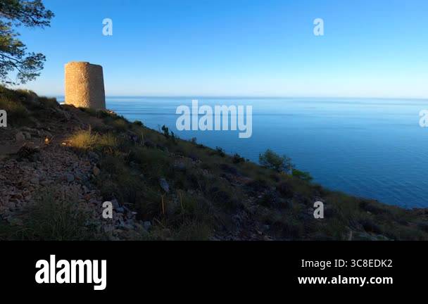 Sunrise over Mediterranean sea. Historic Torre Vigia De Cerro Gordo, a ...