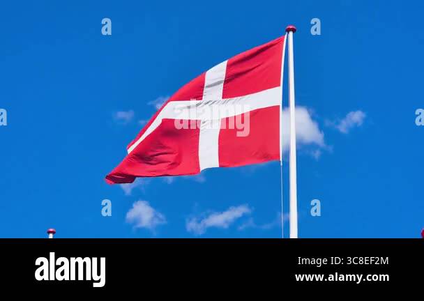 National Flag of Denmark on blue sky Stock Video Footage - Alamy