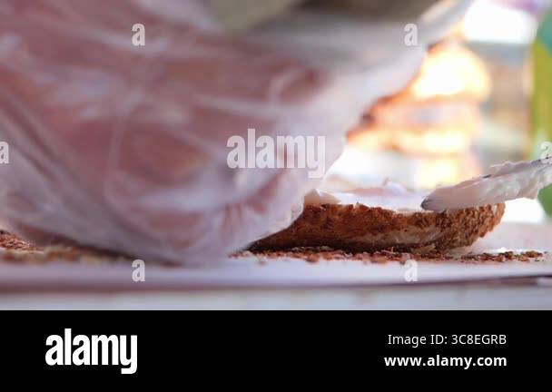 spreading butter on a turkish simit outdoor Stock Video Footage - Alamy