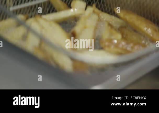 Professional chef working in a commercial kitchen preparing a meal with ...