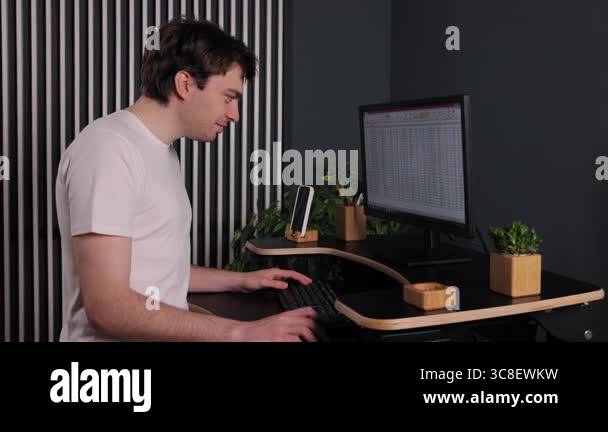 Running computer, man setup, white setup. In white t-shirt, man is ...