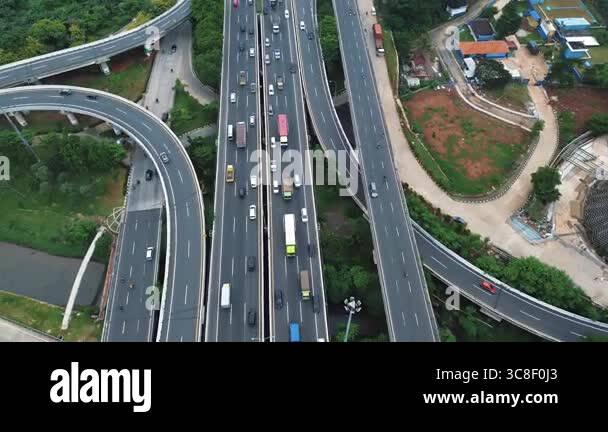 High-angle view of busy city highway interchange with various vehicles ...