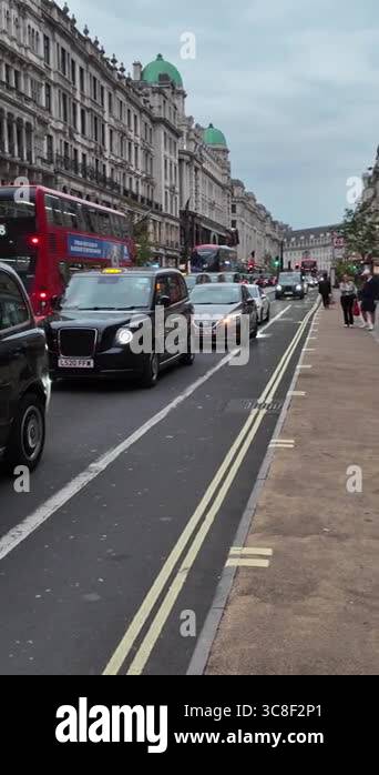 London, uk. April, 17, 2025: black cab and red double-decker bus moving ...