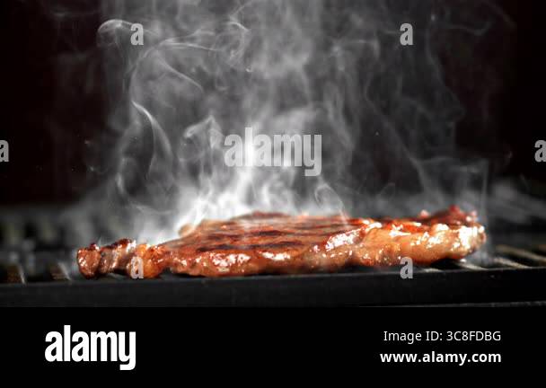 Beef ribeye steak is grilled. Filmed on a high-speed camera at 1000 fps ...