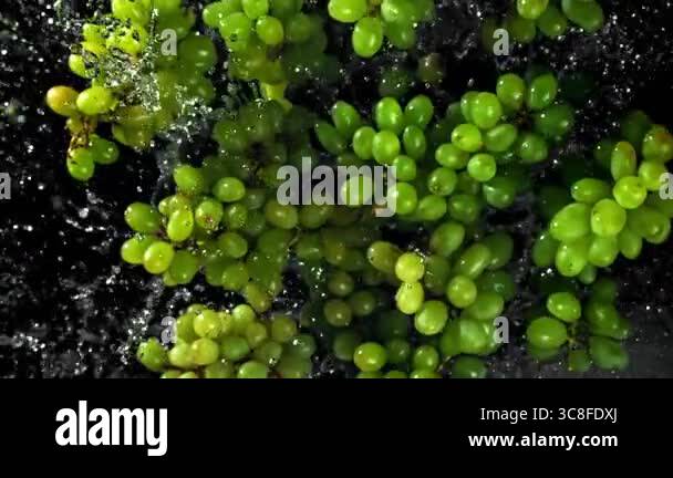 Green grapes fly up and fall down. Filmed on a high-speed camera at ...
