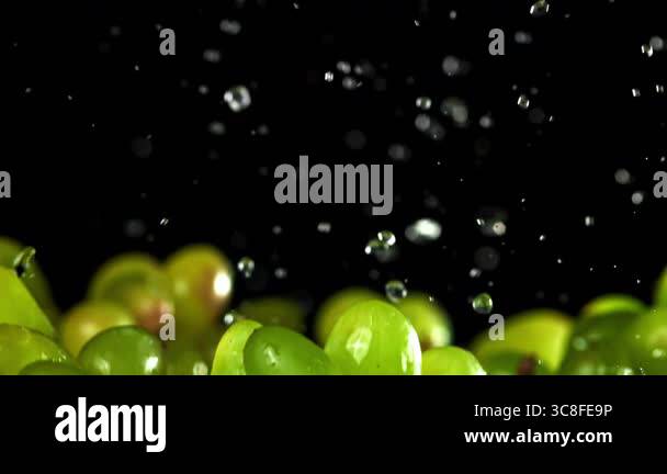 Green grapes fly up and fall down. Filmed on a high-speed camera at ...