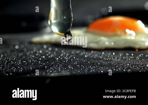 Cooking a fried egg. Filmed on a high-speed camera at 1000 fps. High ...