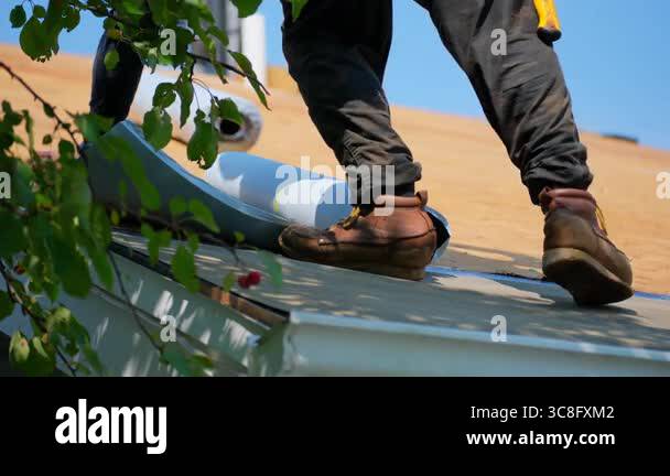 Roofer installing a new insulation for new roof covering. . High ...