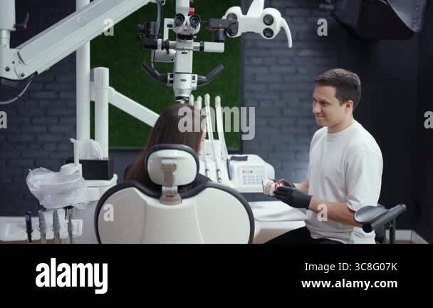 Dentist consulting with patient before dental procedure in a modern ...