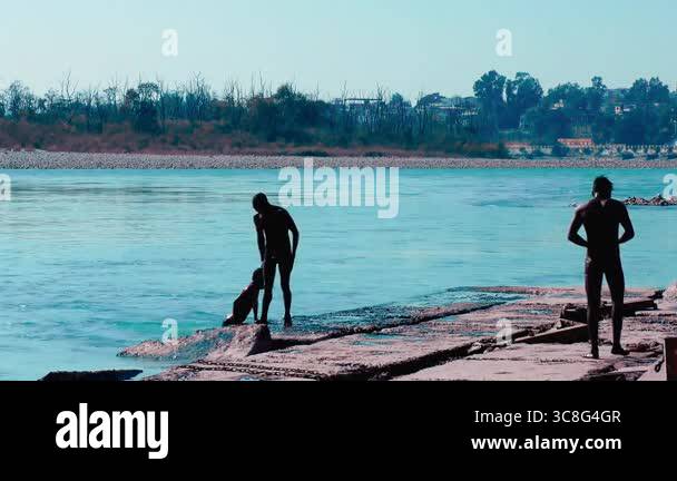 Rishikesh, India January 24, 2025: Young boys swim in the River Ganges ...