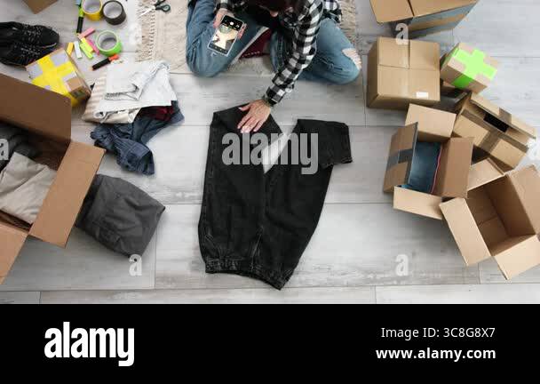 Girl Takes Photos At Home On A Floor Preparing Used Second-Hand Clothes ...