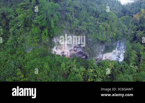 Aerial views show dramatic cliffs set against the green of serene mountain valleys. Hilly ...