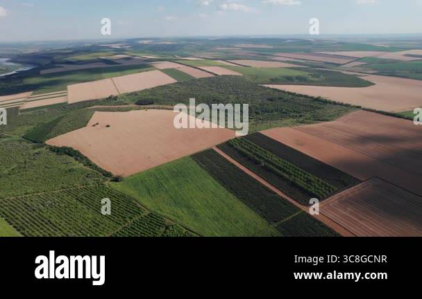 A breathtaking aerial shot captures the vibrant green fields and a ...