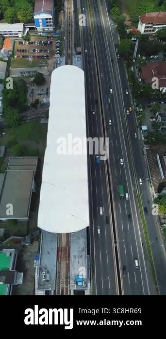 High-angle shot of an MRT station and busy highway with cars moving ...