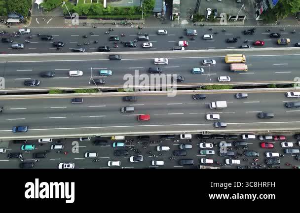 High-angle view of busy highway traffic, cars, motorcycles, and a bus ...