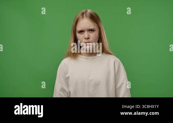 Teens emotions concept. Teenage girl posing at camera with angry ...