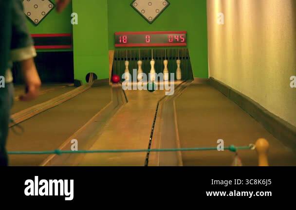 Bowling alley scene featuring a wooden lane, electronic scoreboard, and ...