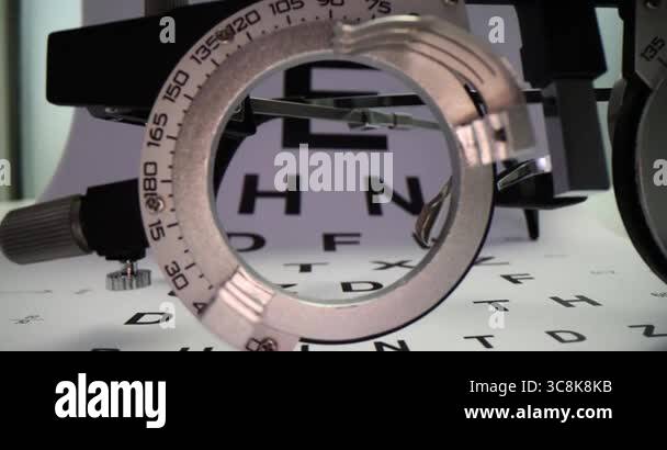 Phoropter measuring eyesight with Snellen chart during ophthalmic ...