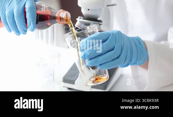 Scientific researcher in gloves transferring carbonated drink from ...