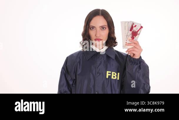 Female FBI agent holds bloody money and handcuff on white background ...