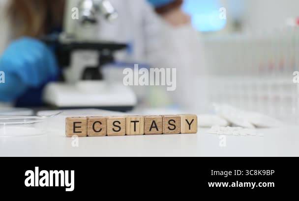 Researcher in blue gloves works with microscope near wooden blocks ...