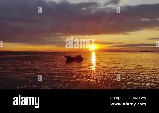 Boat Moving on the Calm Waves of the Sea Sparkling at Sunset Footage ...