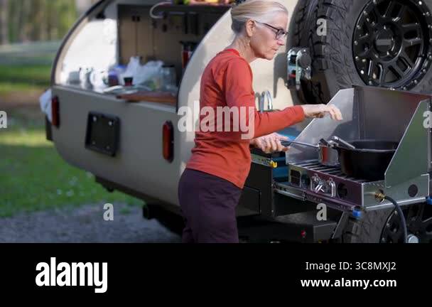 Danese, WV, USA - 04 30 2025: A mature woman prepares delicious food ...