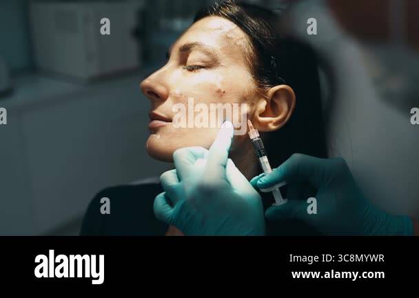 Attractive young woman is getting a rejuvenating facial injections at ...