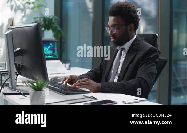 Confident happy African American man working typing computer pc manager ...