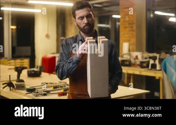 Caucasian carpenter builder wood master man holding wooden craft in ...