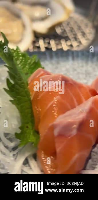 Young asian woman eating sashimi set in japanese restaurant. High ...