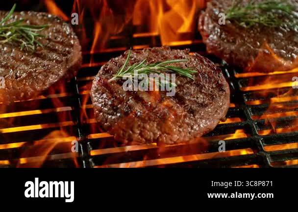 Slow Motion of Beef Meat on a Grill with Roaring Flames . Camera ...