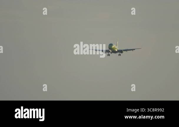 Long shot of passenger airplane is approaching landing. Jet plane is ...