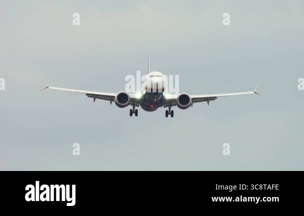 Passenger plane landing while banking in windy weather. Aircraft ...