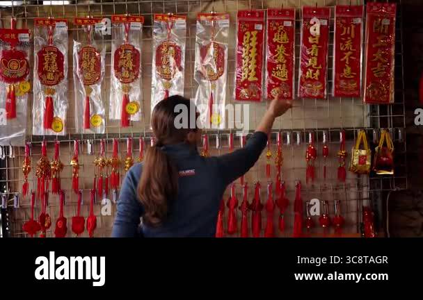 Taichung, Taiwan-14 February, 2028: A woman browses festive red and ...