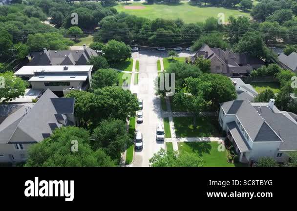 Suburban street toward community park baseball fields in affluent ...