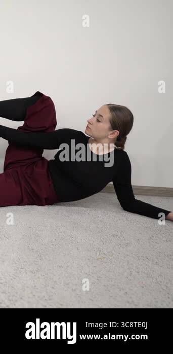 A ballet dancer showcases a graceful stretch, highlighting flexibility ...