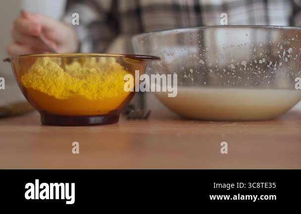 Minimalist slow living kitchen scene with flour and batter in bowls ...