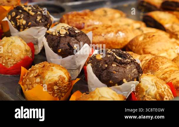 Freshly baked muffins and pastries attract customers at the bakery ...
