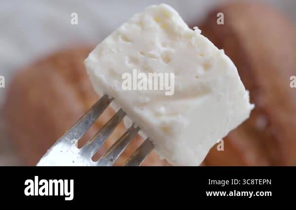 Explore the process of sampling fresh local cheese with a fork Stock ...