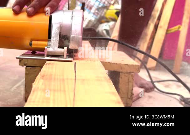 Carpenter using electric wood cutting machine to finish the carpentry ...