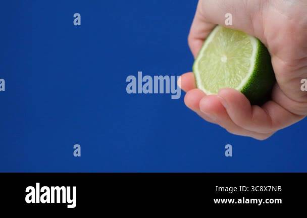Lime Juice Explosion. Hand Pressing Half a Lime Stock Video Footage - Alamy