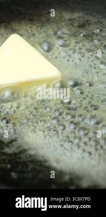Butter is melted in a pan, the process of frying in butter slow motion ...
