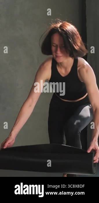 Vertical video. Pilates training. Fitness workout. Athletic woman in ...